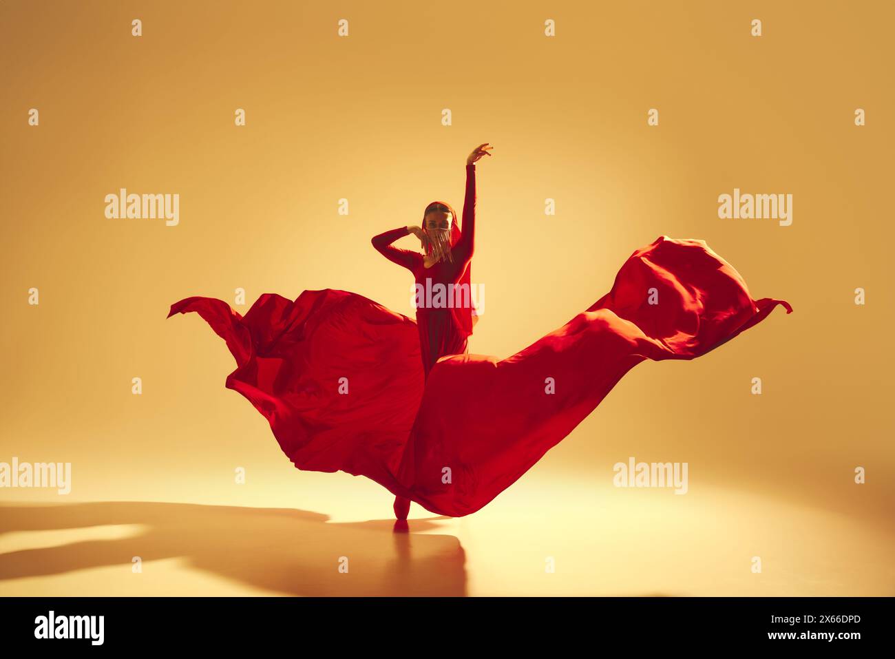 Artistic and deep performance Woman, female dancer in flowing red dress ...