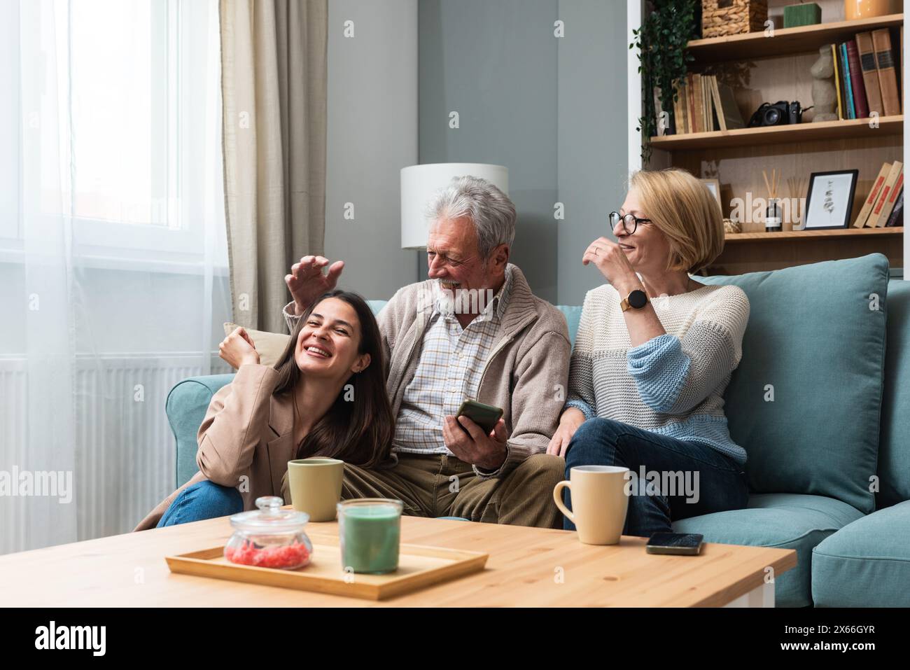 Simple living. Daughter visited her senior parents at home, looking at ...