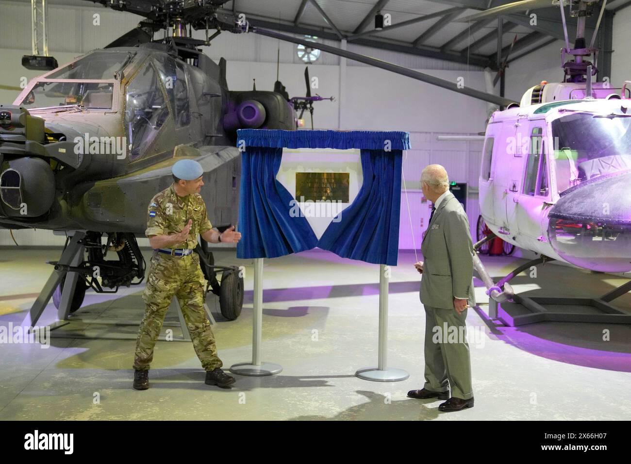 King Charles III unveils a plaque during a visit to Army Aviation ...