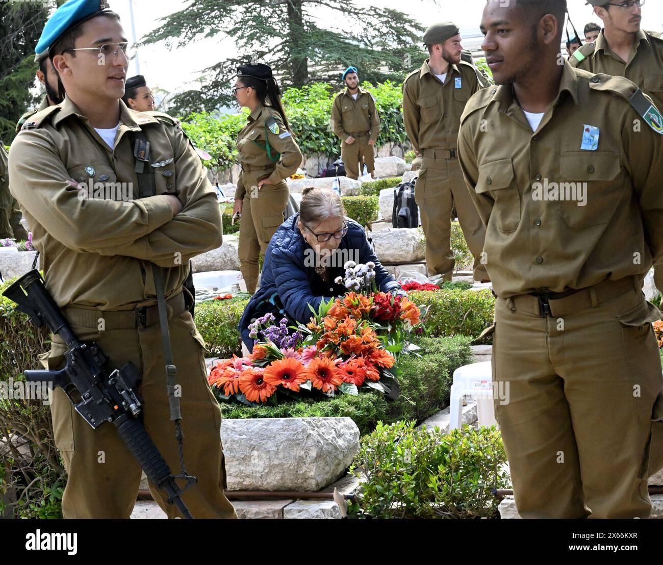 Jerusalem, Israel. 13th May, 2024. A woman places flowers on the grave ...