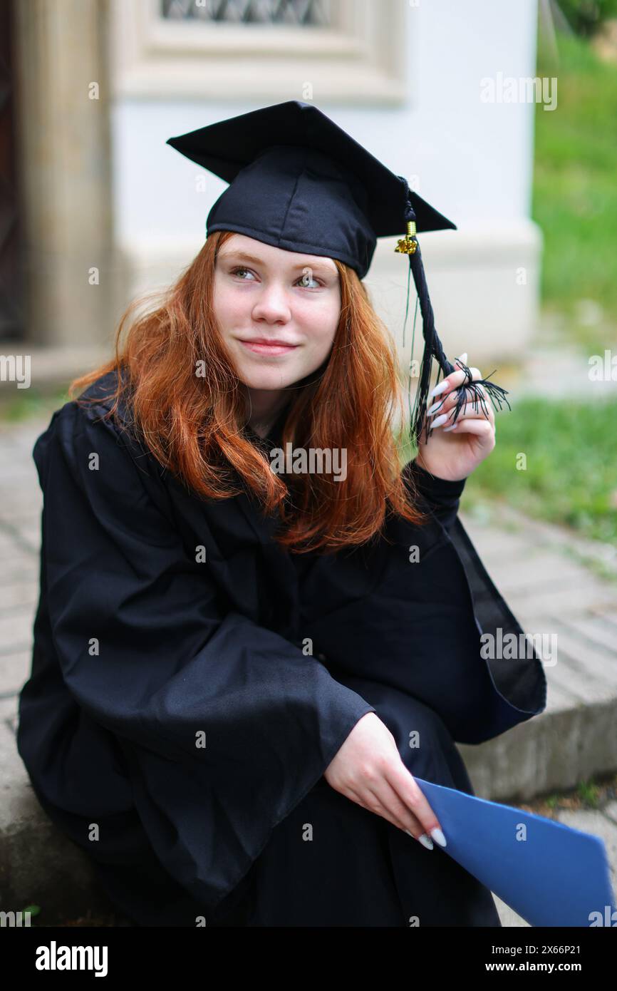 Celebrating graduation ceremony concept. Portrait of happy student girl ...