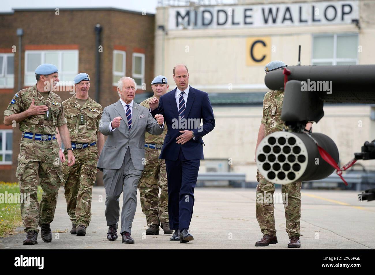King Charles III and the Prince of Wales walk beside an Apache ...