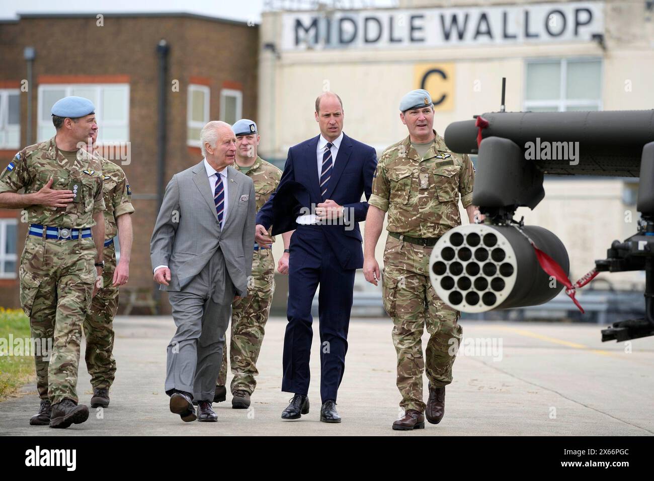 King Charles III and the Prince of Wales walk beside an Apache ...