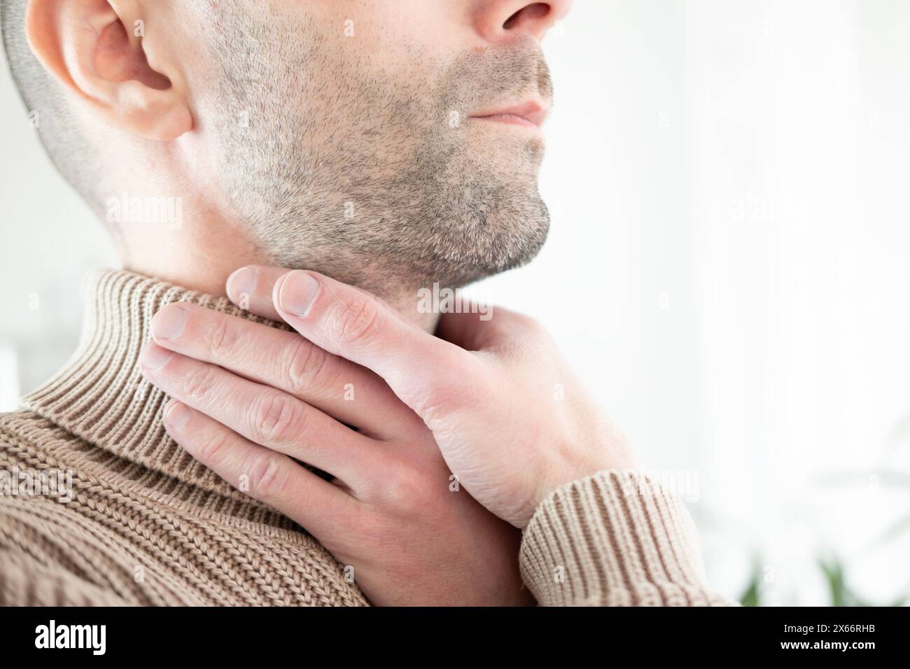 young male neck, man patient holding affected area, experiencing throat ...