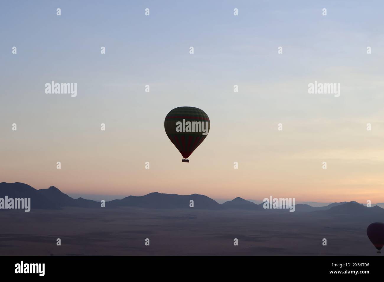 Hot air balloon ascends over the Atlas mountains in Marrakech Stock ...