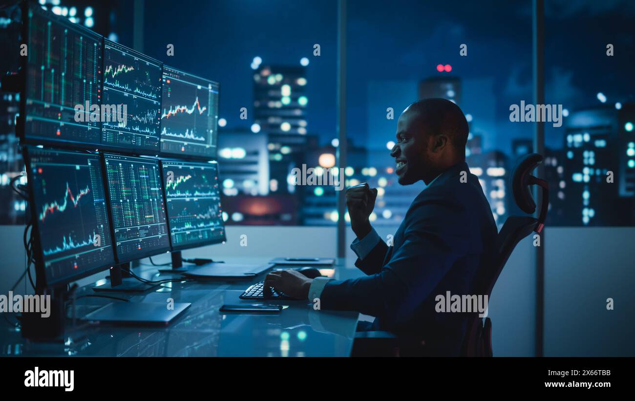 Stock Market Day Trader Working on Computer with Multi-Monitor Workstation with Real-Time ...