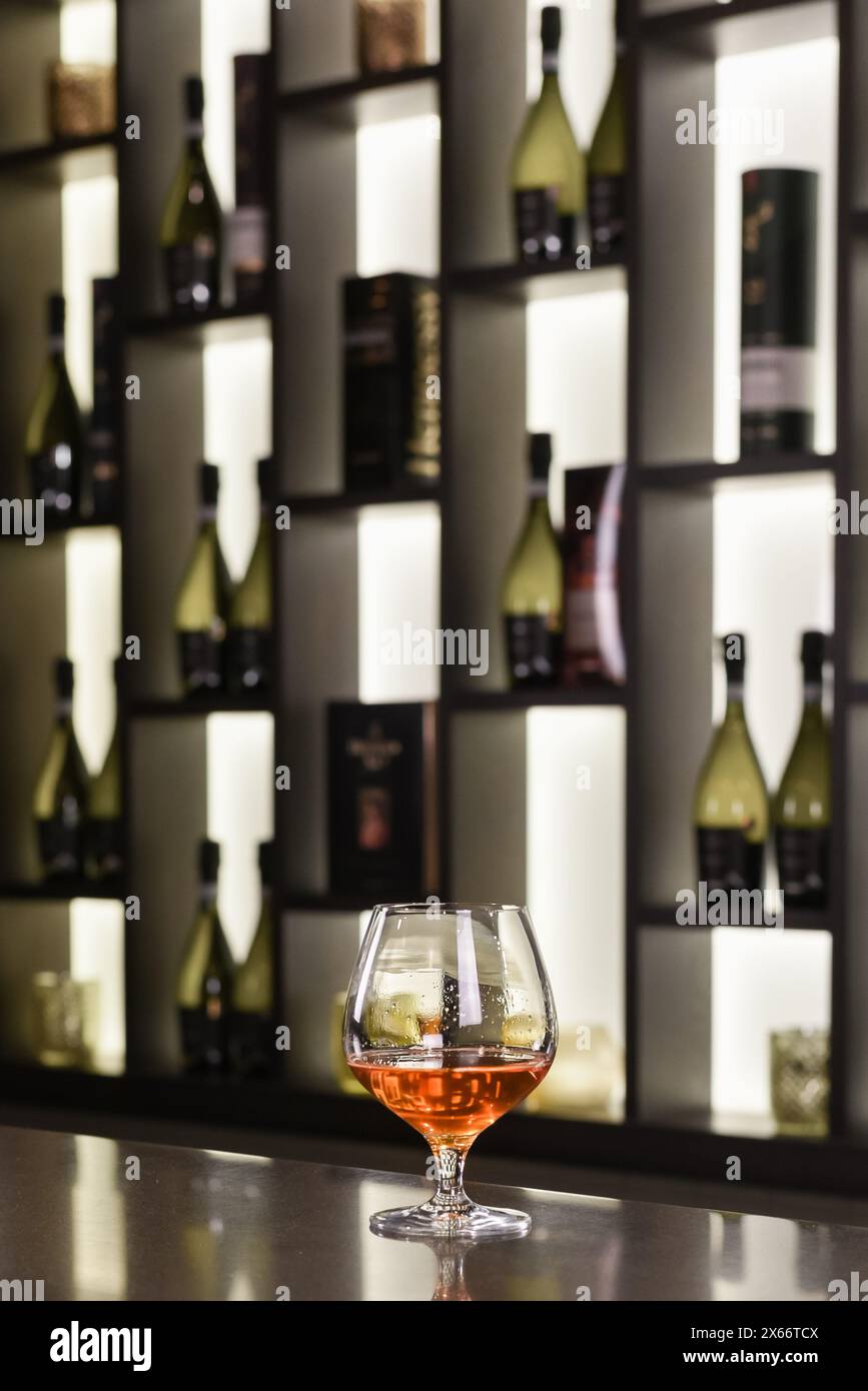 Glass of alcoholic drink on the bar counter. Production and sale of ...