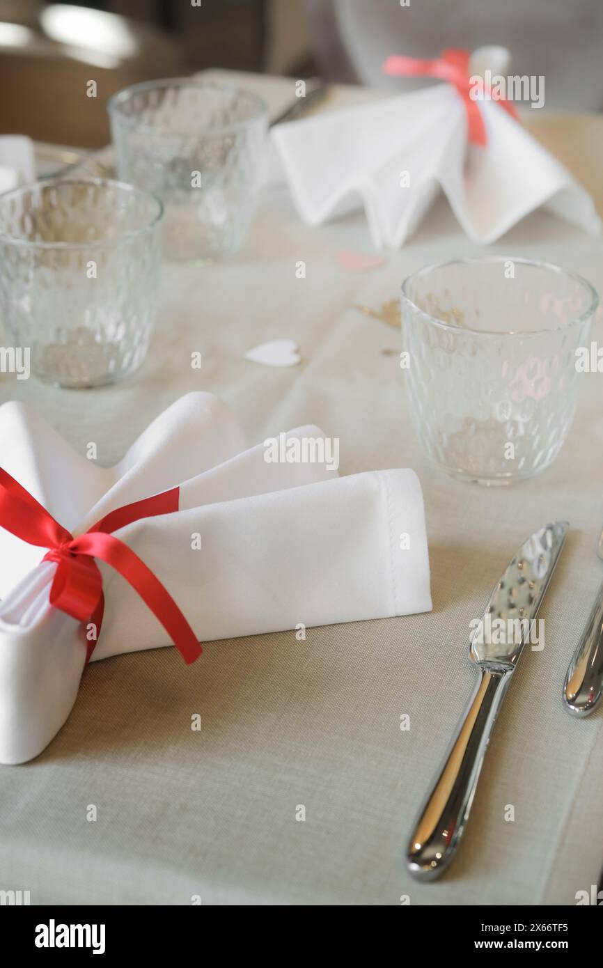 Serving cutlery and decorating a table for an event in a restaurant ...