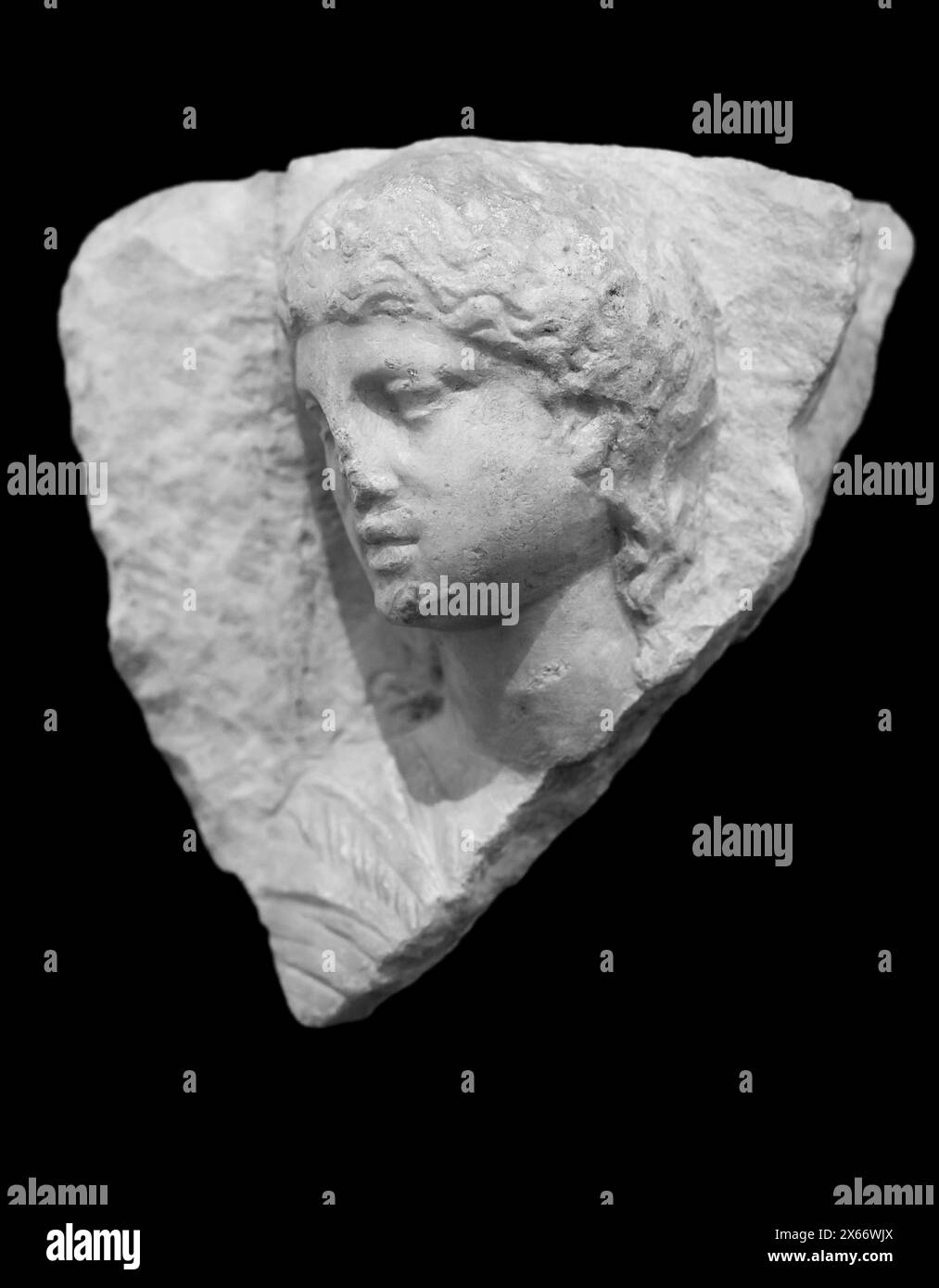 Black and white photo of male young head of ancient roman carved in a ...