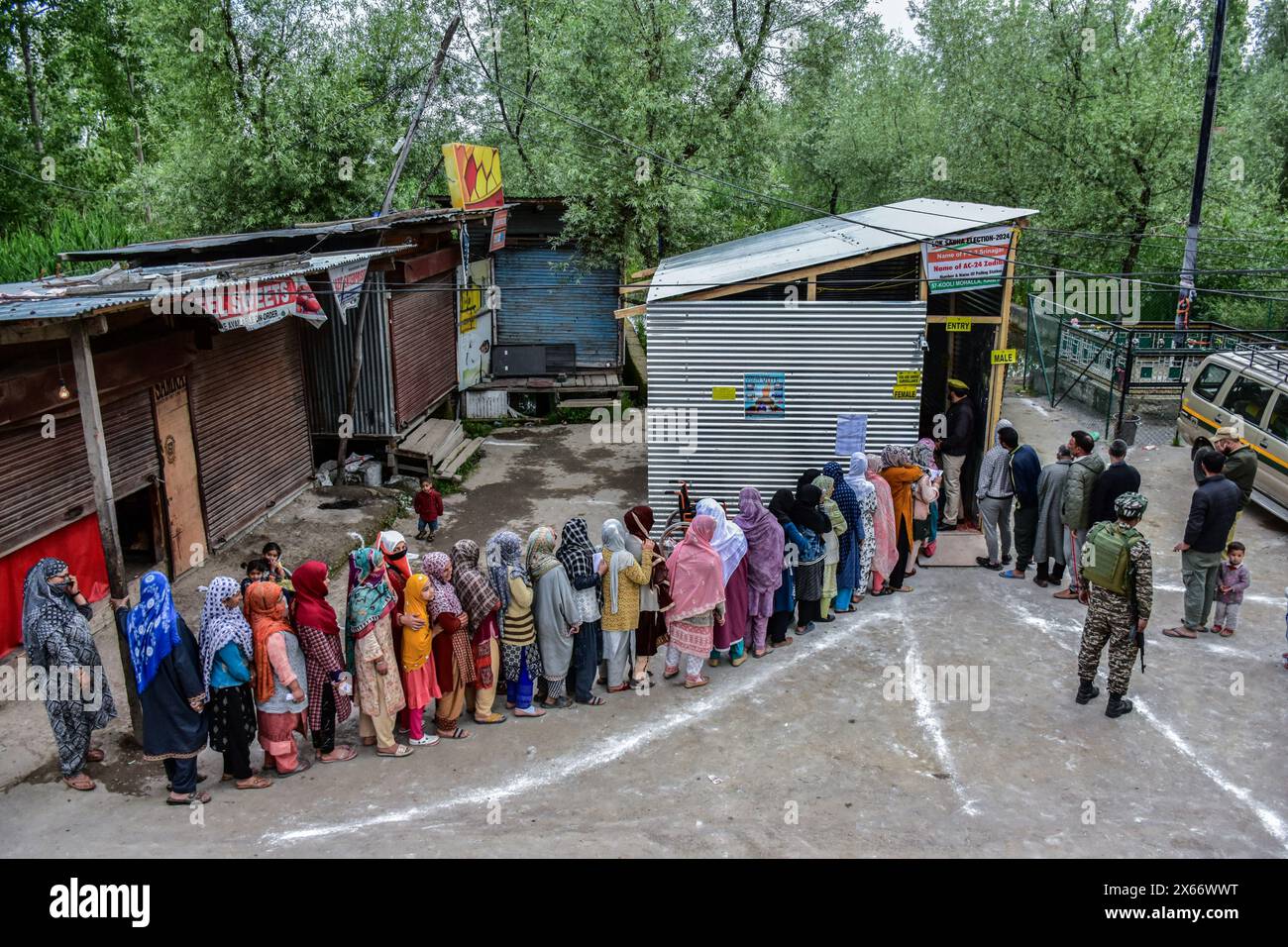 Kashmir, India. 13th May, 2024. Kashmiri voters queue up to cast their ...