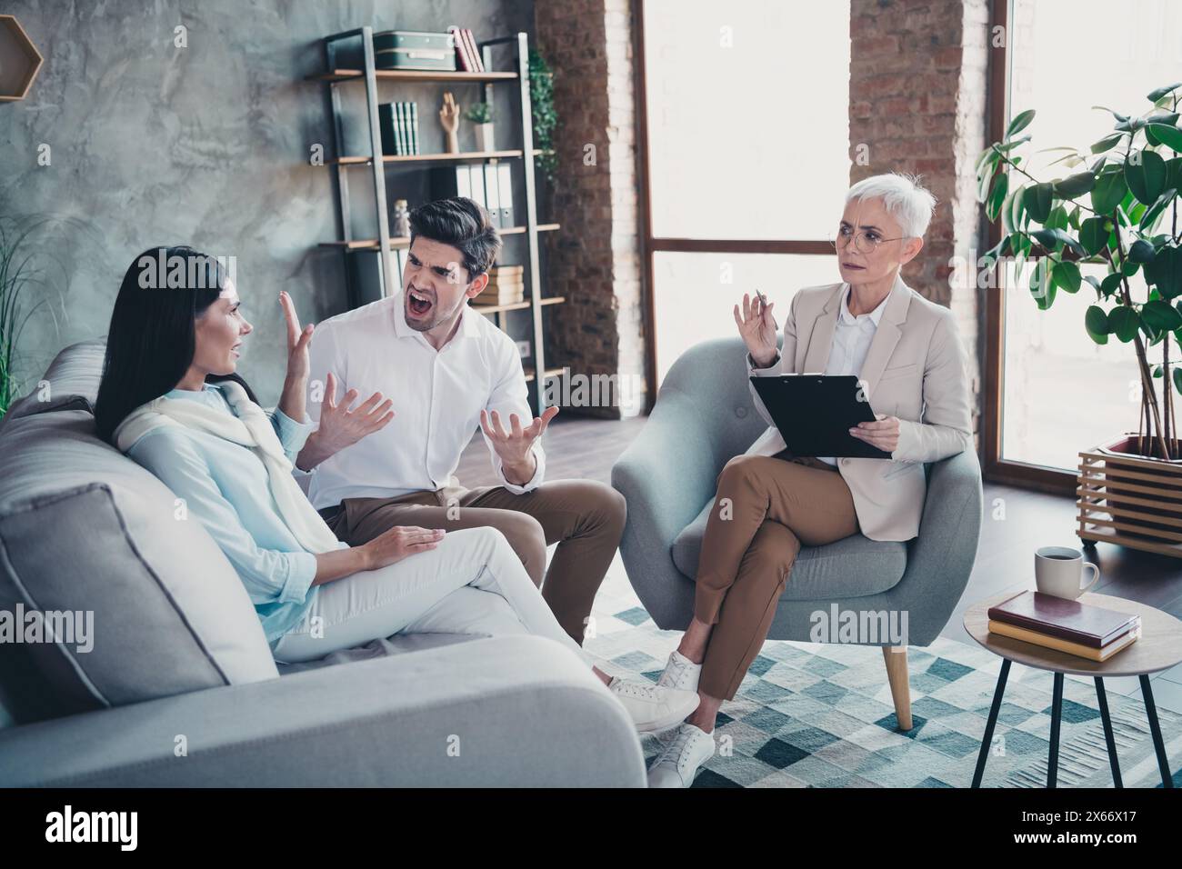 Photo of young couple argue shout appointment psychotherapist loft ...