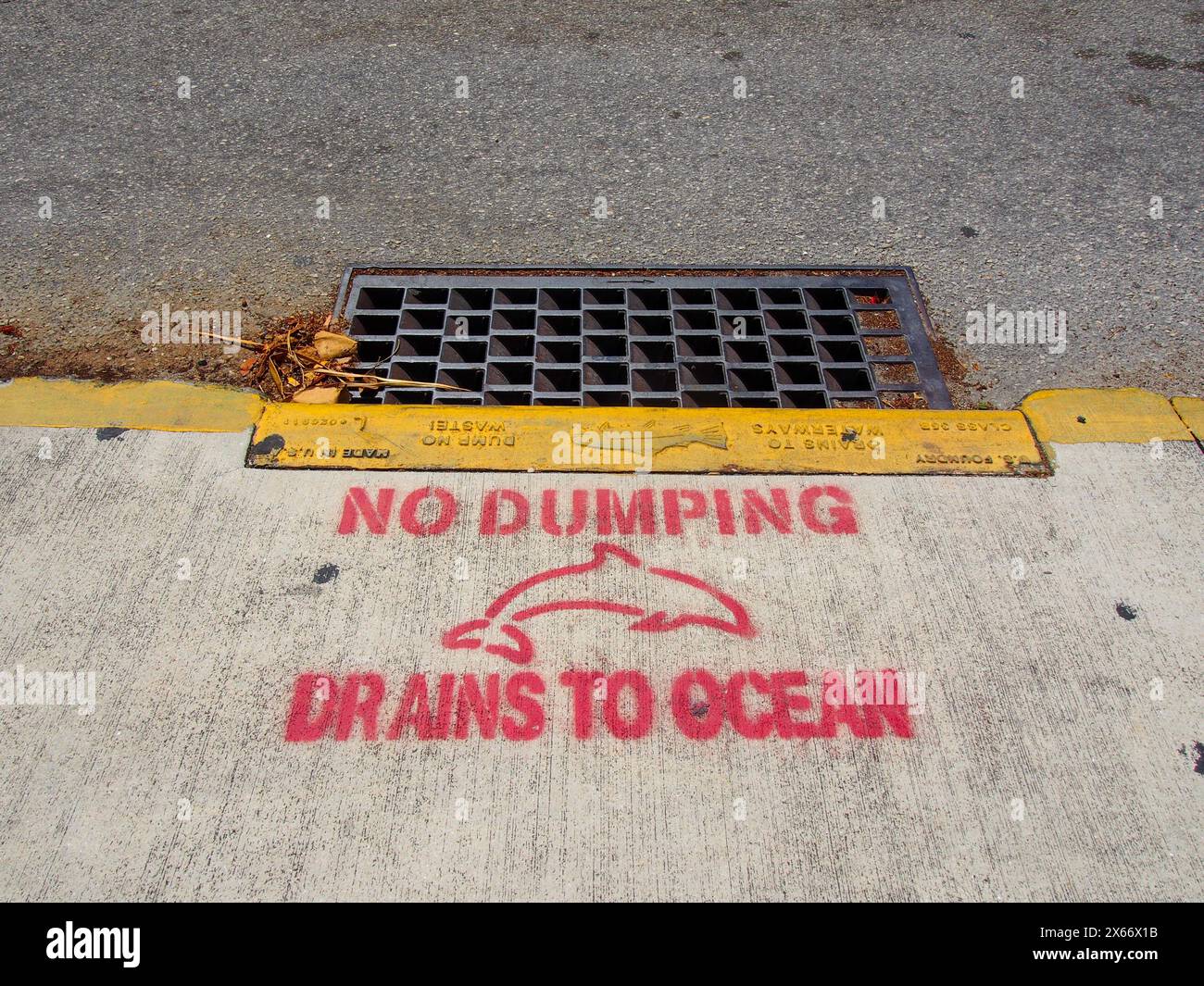 No Dumping Drains to Ocean sidewalk stamped sign at a storm drain in ...
