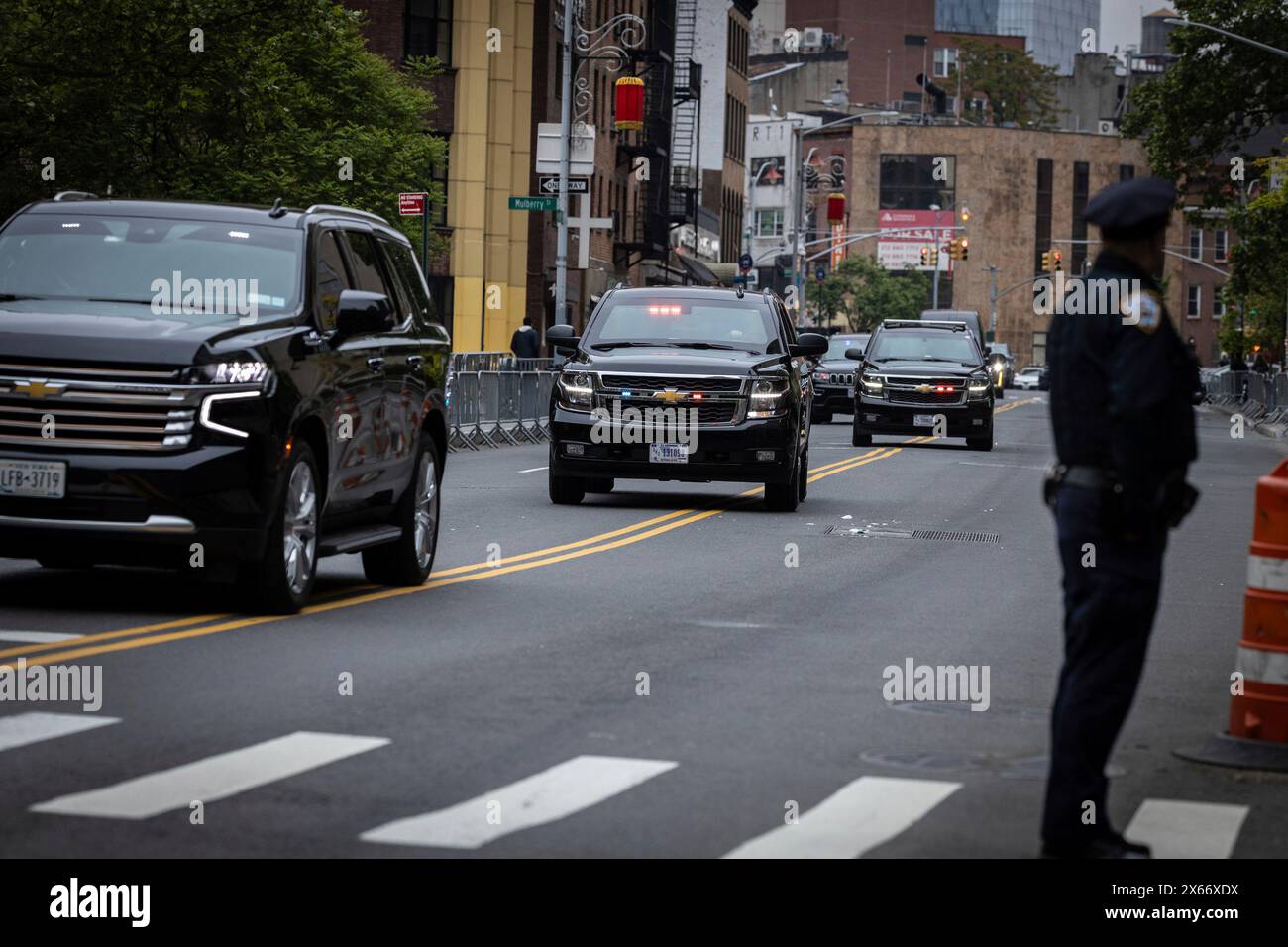 New York City police officers stand guard as the motorcade carrying ...