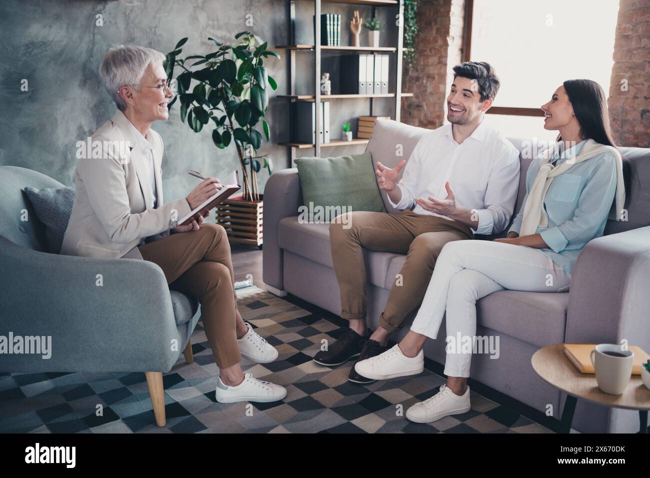 Photo of young couple sit couch speak appointment psychotherapist loft ...