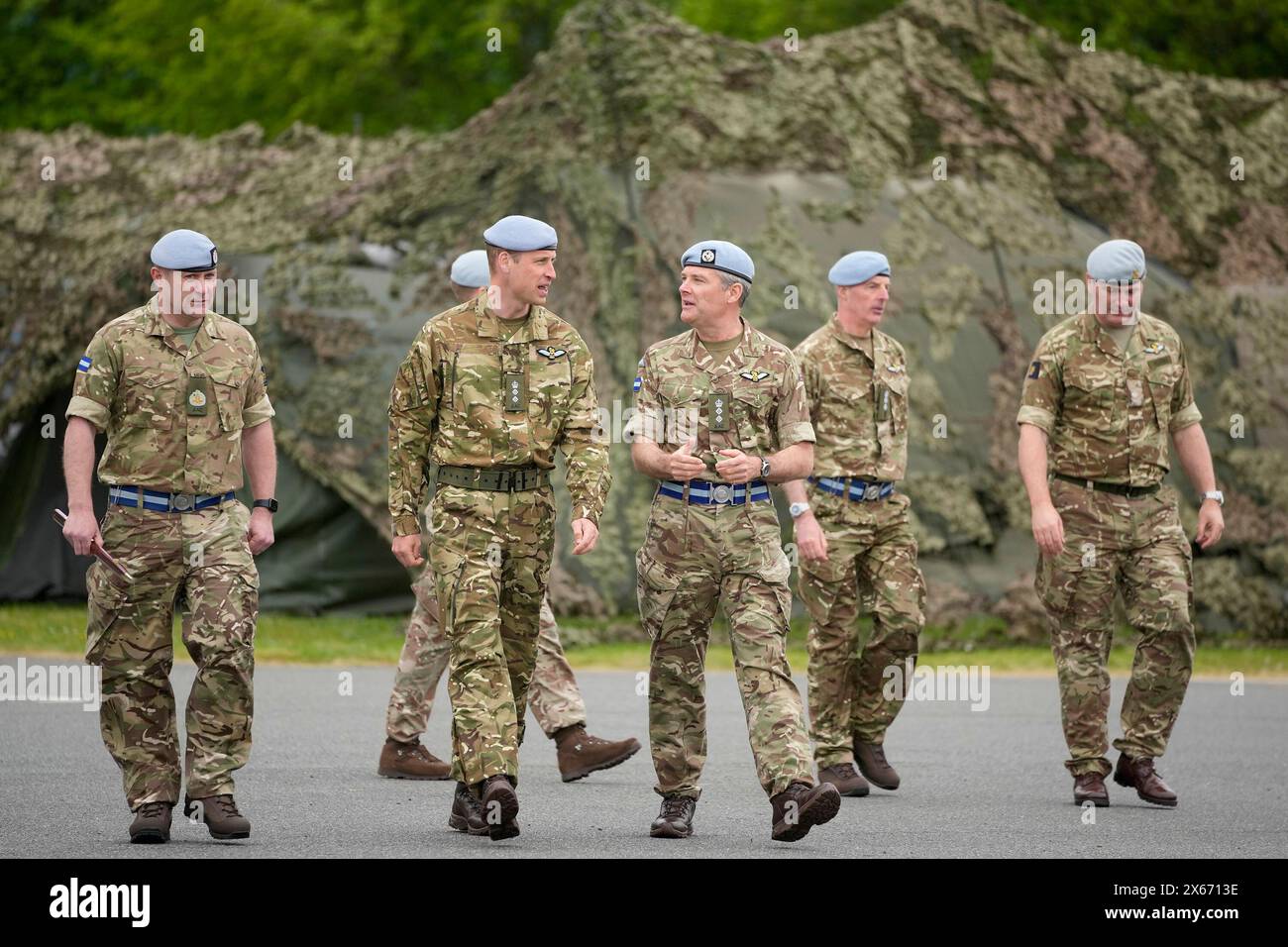 The Prince of Wales (second left) walks with service personnel at the ...