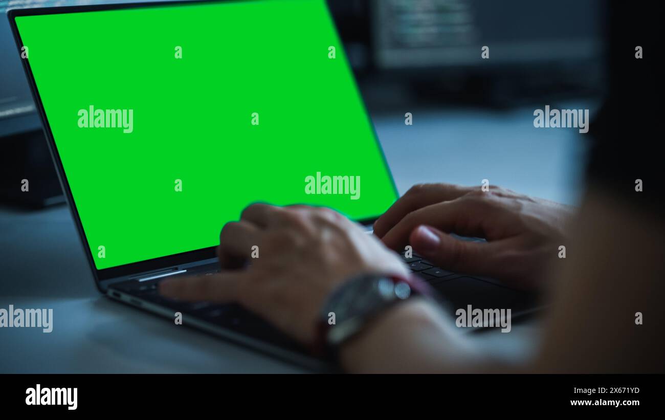Close-up Focus on Person's Hands Typing on the Green Screen Chroma key Laptop Computer Keyboard ...