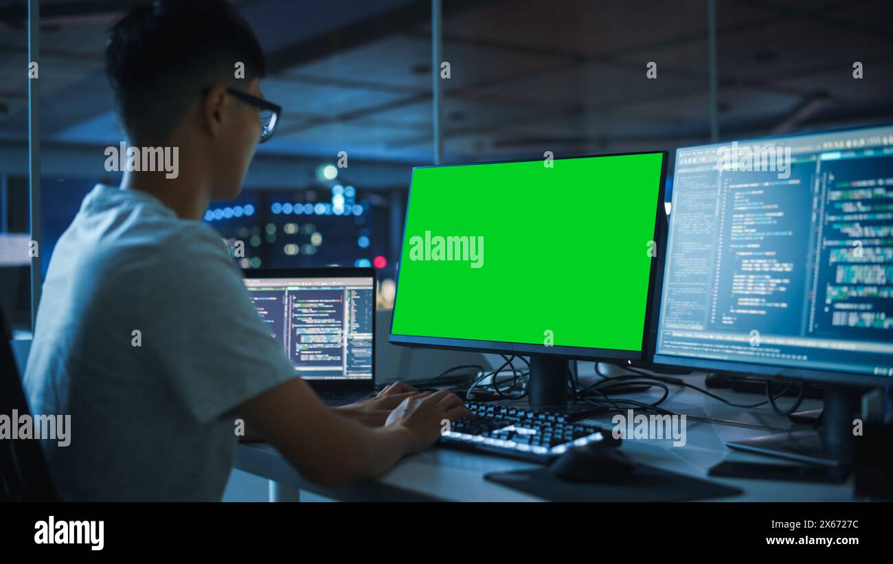Night Office: Young Japanese Man in Working on Green Screen Chroma Key ...