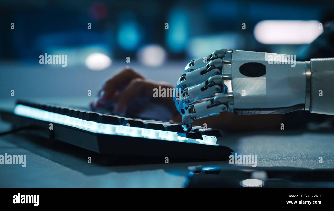 Close Up On Hands Programmer With Disability Using Prosthetic Arm To Work On Backlit Computer