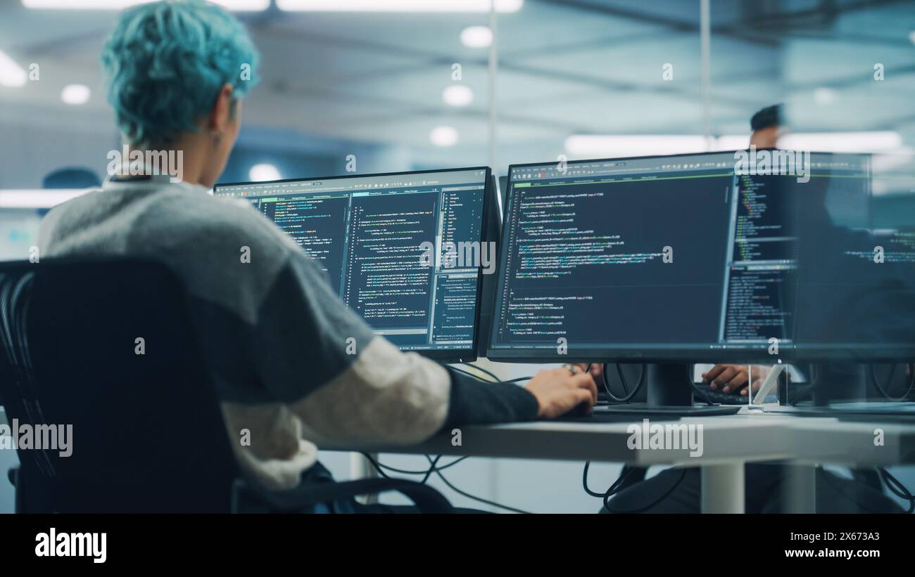In Diverse Office: Female Programmer is Working on Desktop Computer, Screen Shows Coding ...