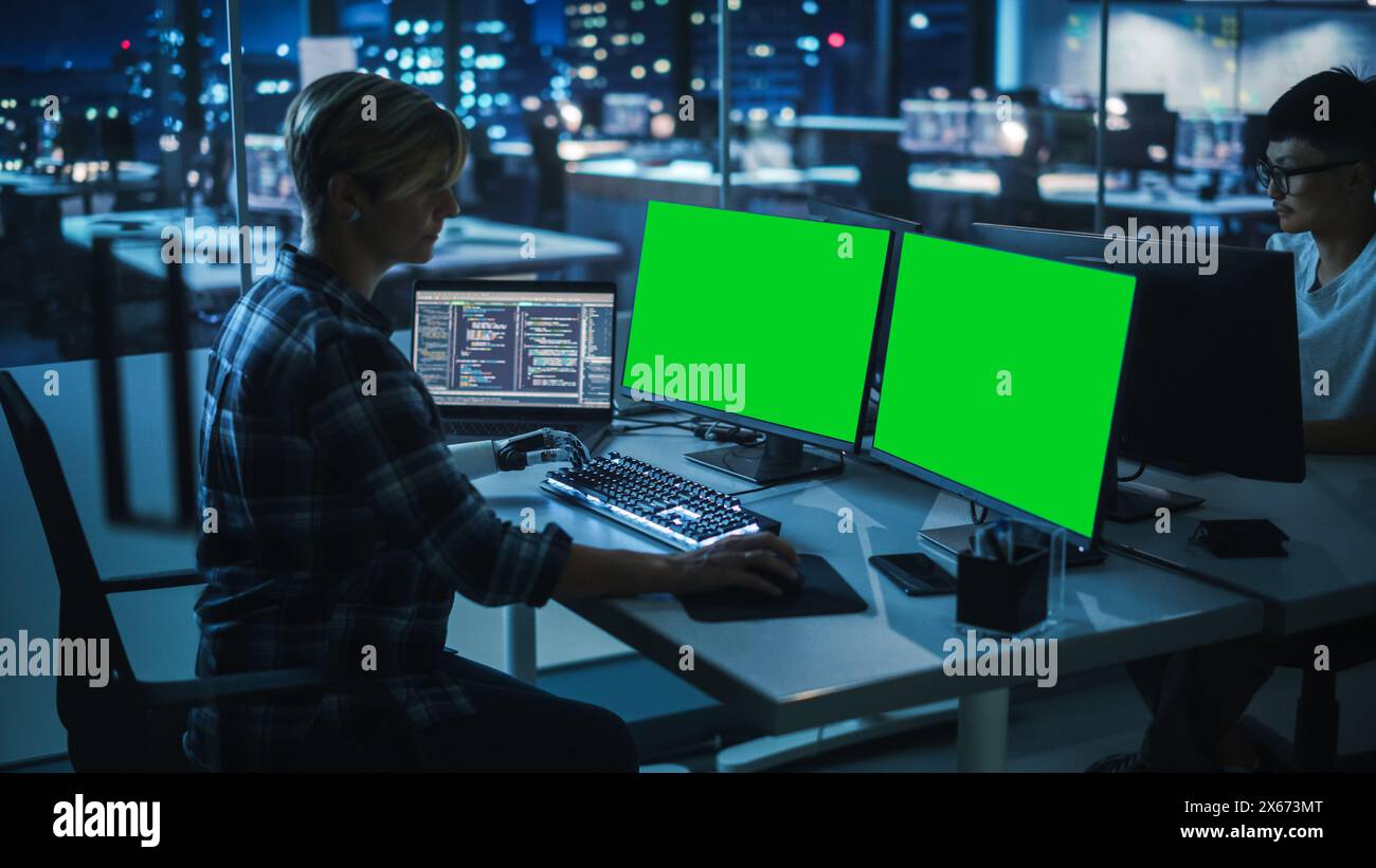 Night Office: Person with Disability Using Prosthetic Arm to Work on Green Screen Chroma Key ...