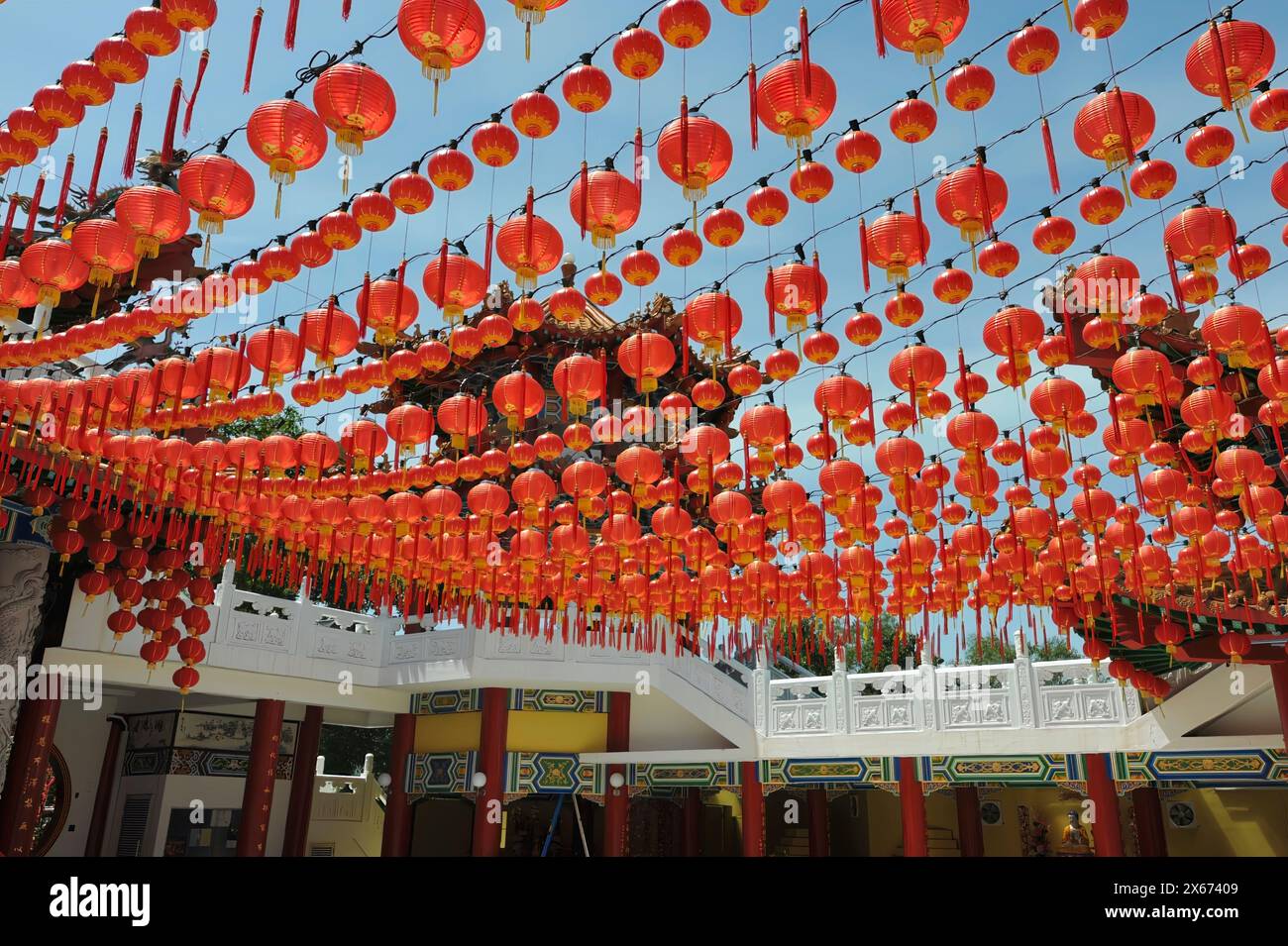 vibrant display of chinese red lanterns at a temple festival. a large ...