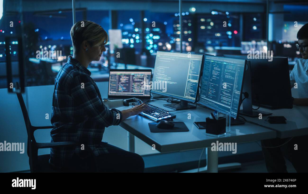 Night Office: Programmer With Disability Using Prosthetic Arm to Work on Illuminated Computer ...