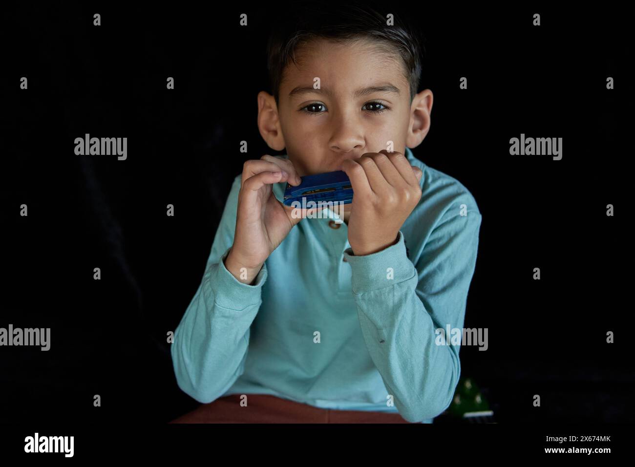 Boy playing harmonica hi-res stock photography and images - Alamy