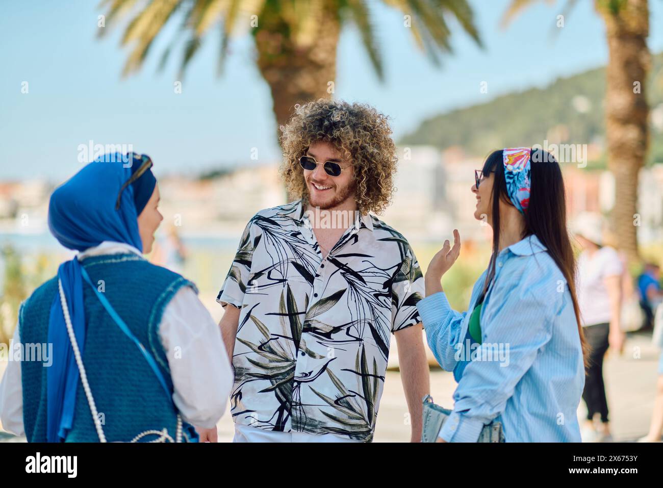 Coastal Conversations: Group of Tourists Planning Their Mediterranean ...