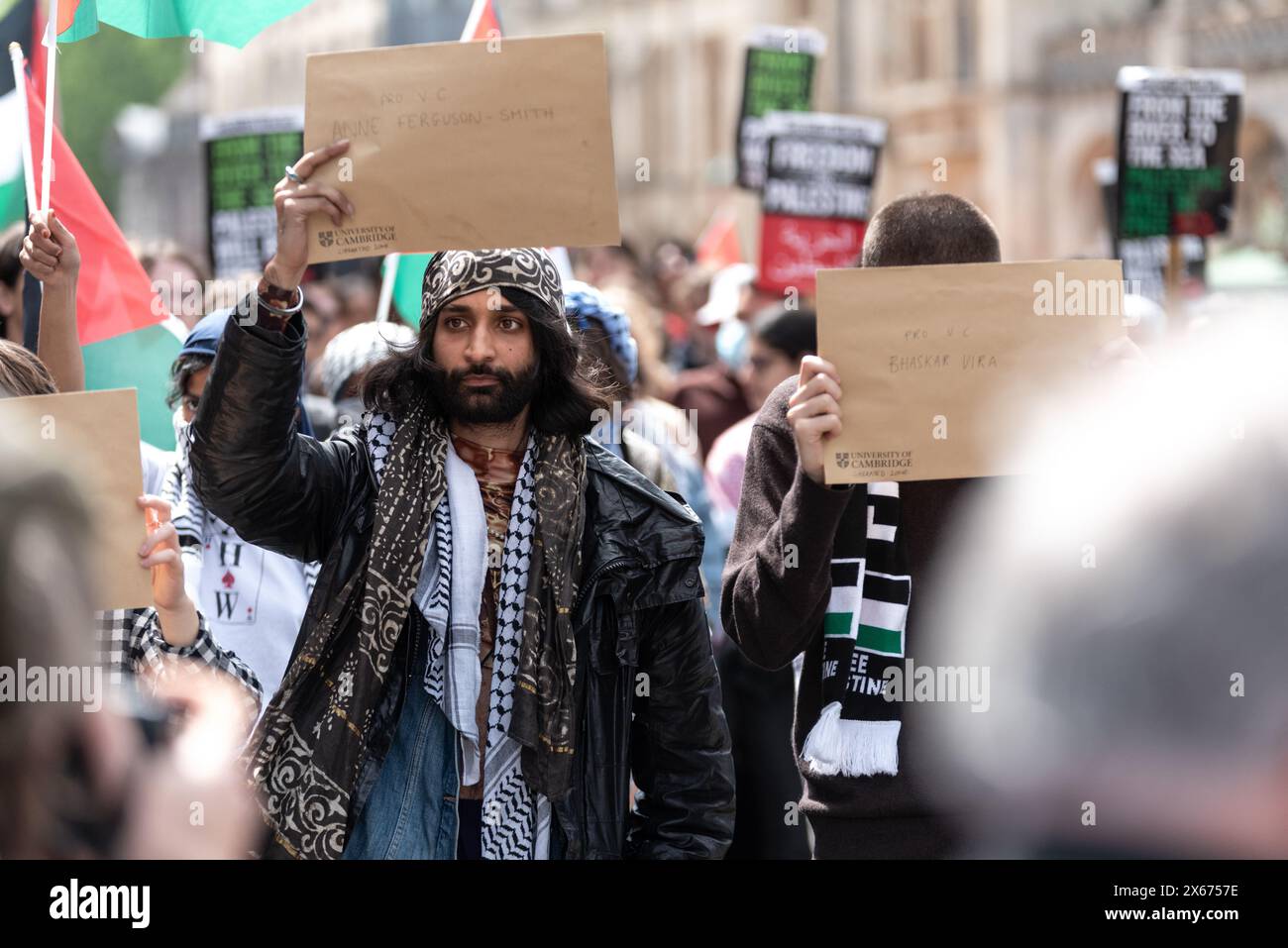 Cambridge, UK. 7th May, 2024. Students march holding Palestinian flags ...