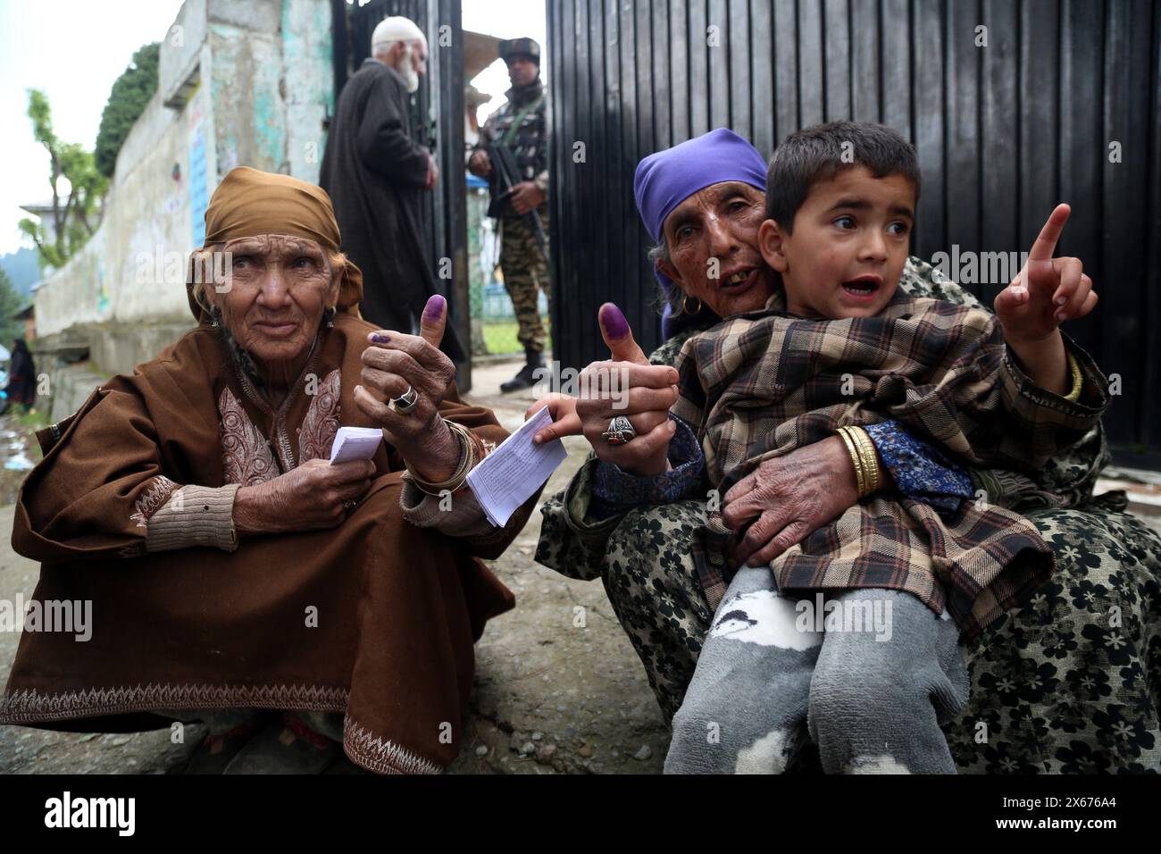 Shopian, India. 12th May, 2024. People queue to vote in the 4th phase ...