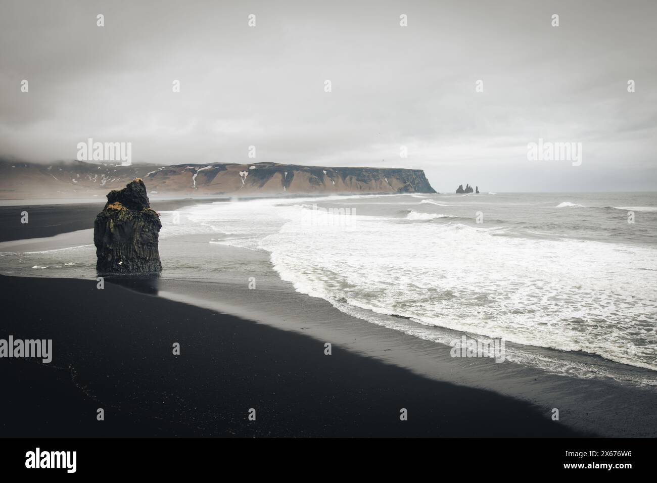 Reynisfjara Beach coast, majestic big rock formations cliff, foam waves ...
