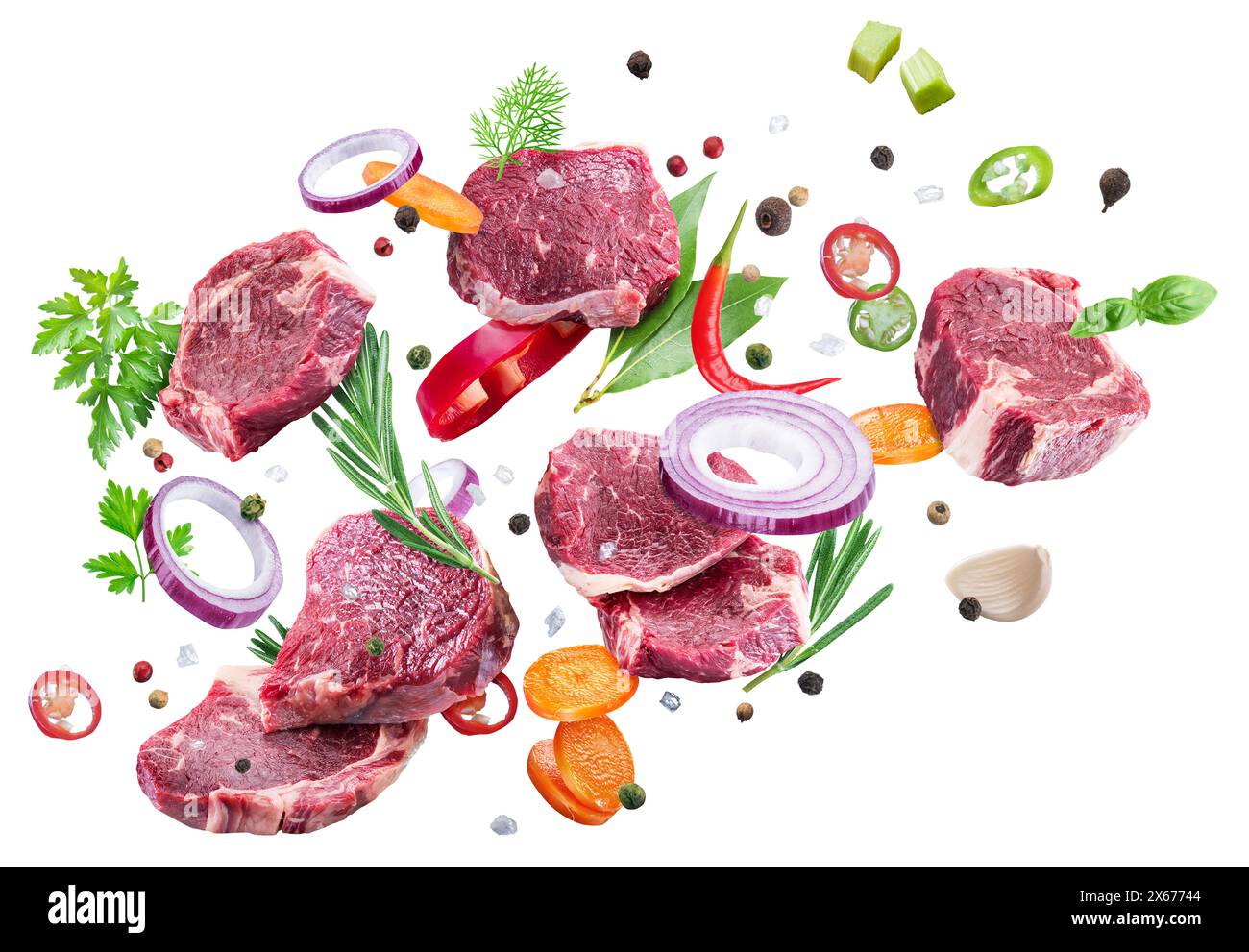 Raw beef steaks, herbs and pieces of vegetables levitating in air on ...