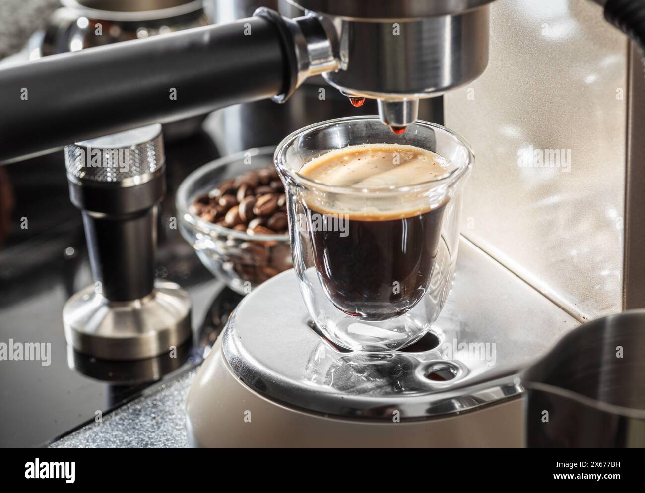 Automatic coffee machine. Pouring coffee into the coffee cup closeup ...