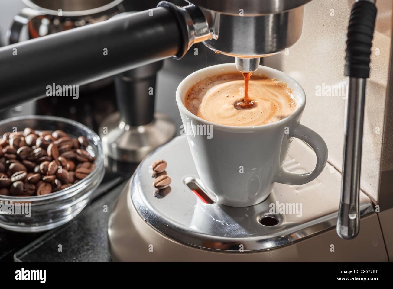 Automatic coffee machine. Pouring coffee into the coffee cup closeup ...