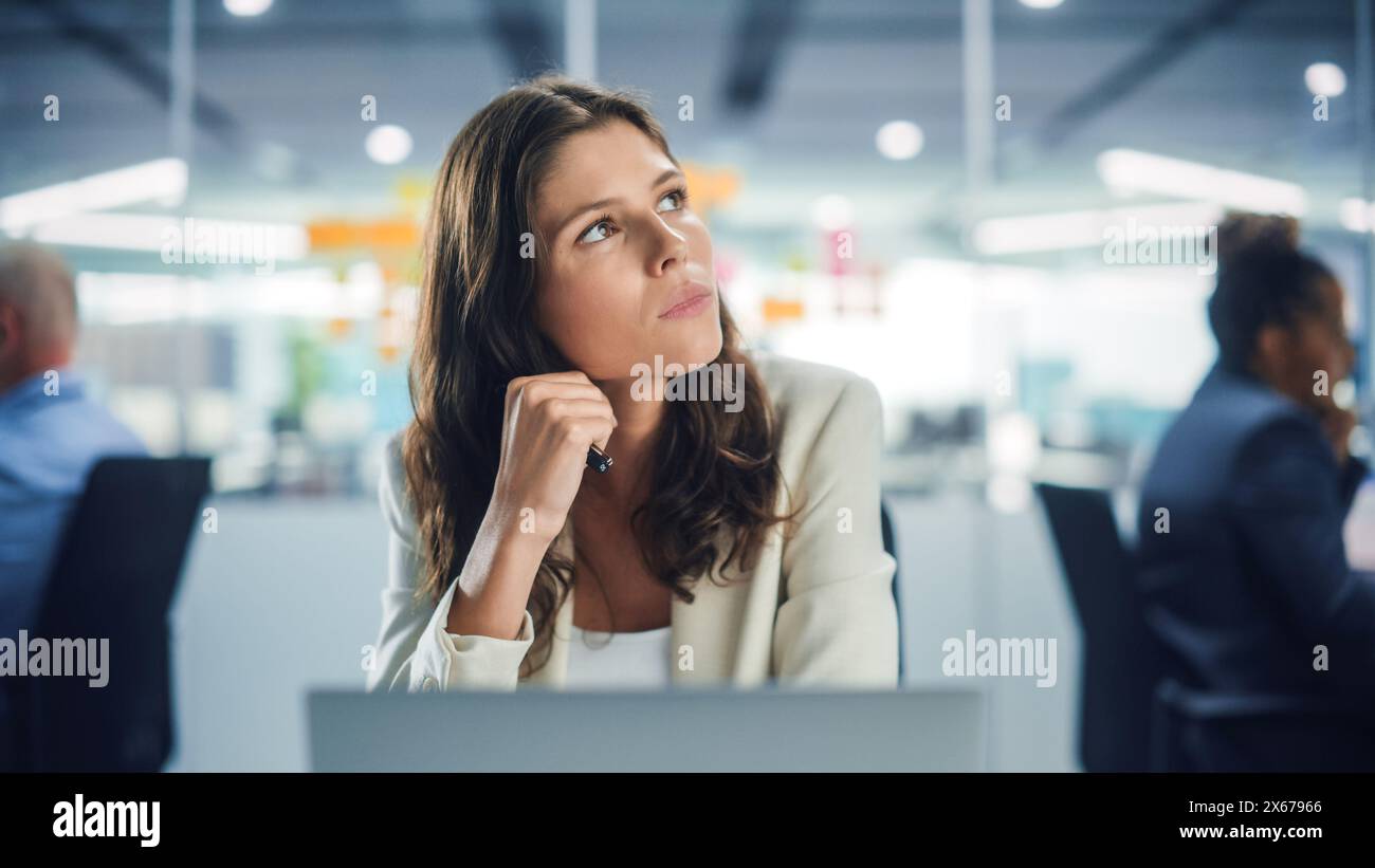 Young Serious Female Manager Using Computer in Modern Office ...
