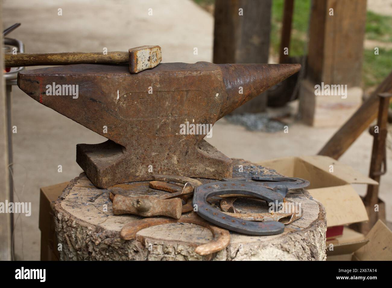 Historic Anvil and hammer in blacksmith workshop Stock Photo - Alamy