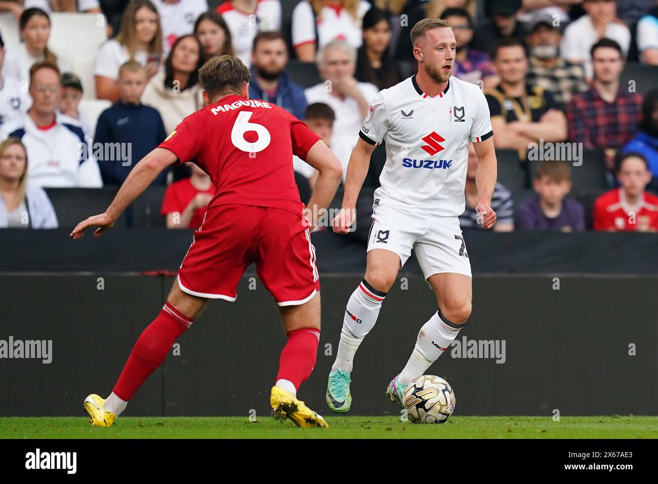 MK Dons' Stephen Wearne takes on Crawley Town's Laurence Maguire during ...