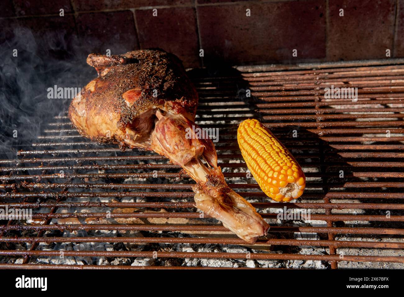 leg of lamb cooking on the grill with a piece of corn Stock Photo - Alamy