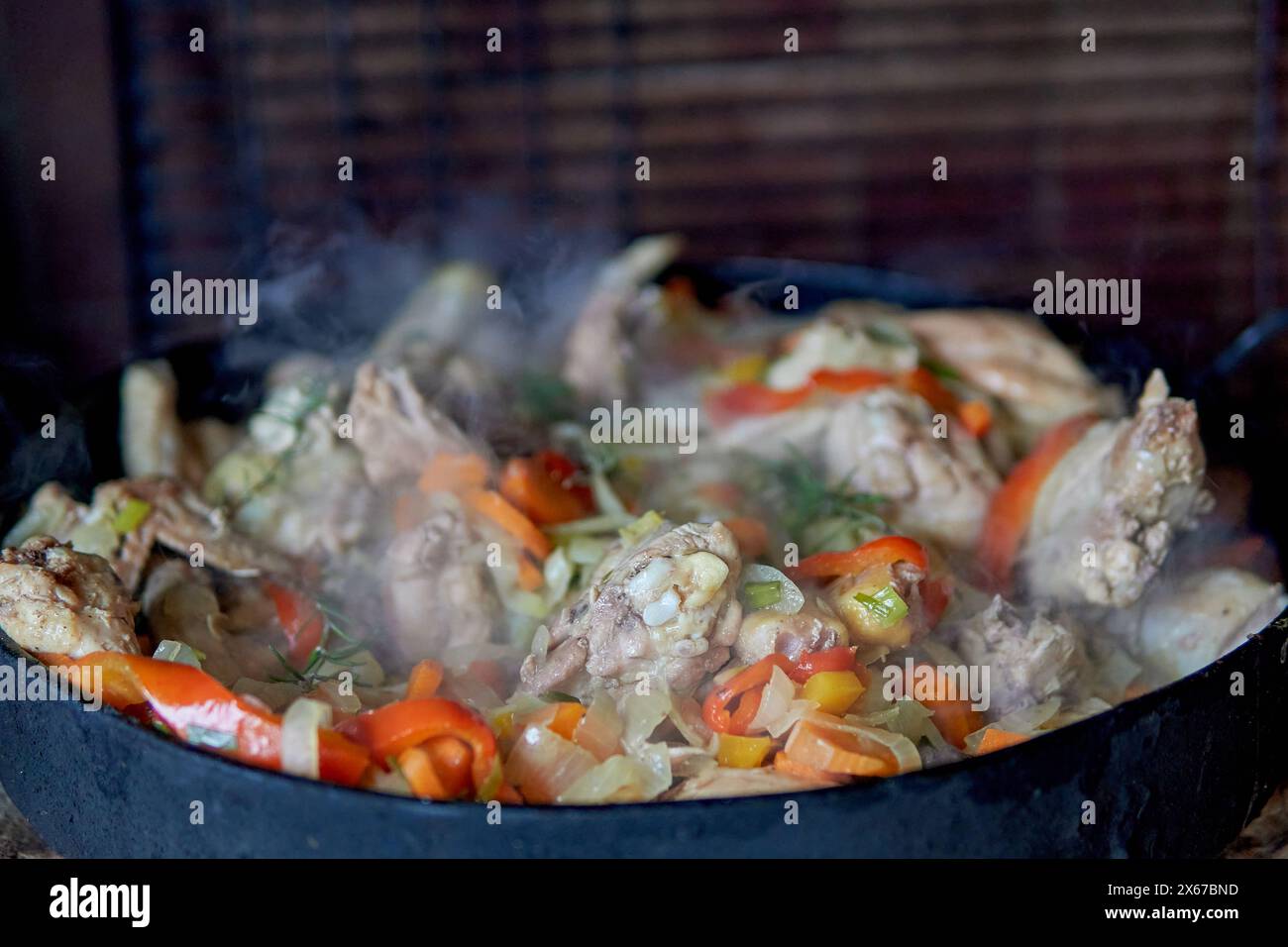 Pollo al disco with vegetables cooked in an old plow disk, typical ...