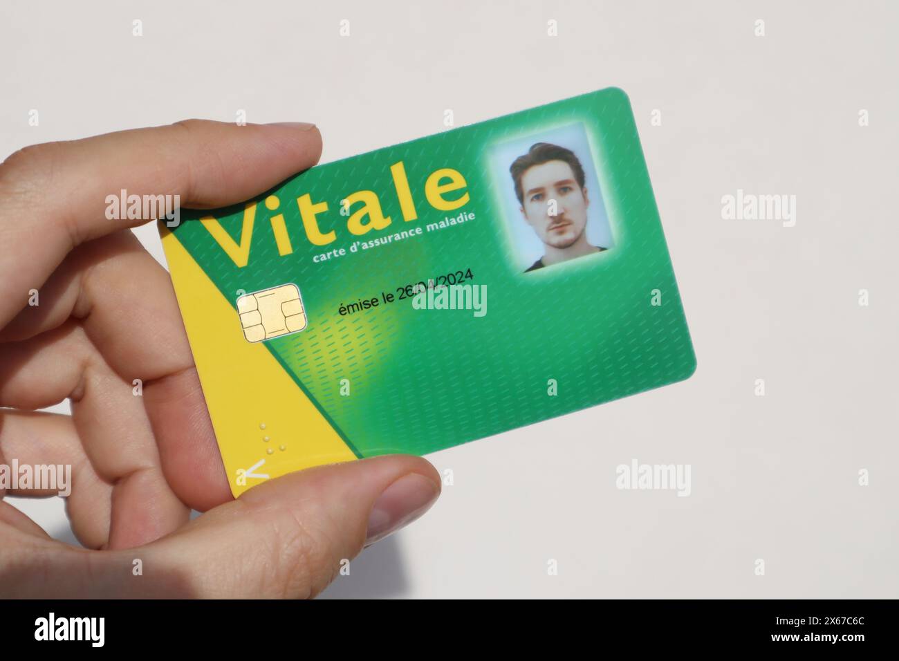 Young man's health insurance card of the national health care system in ...