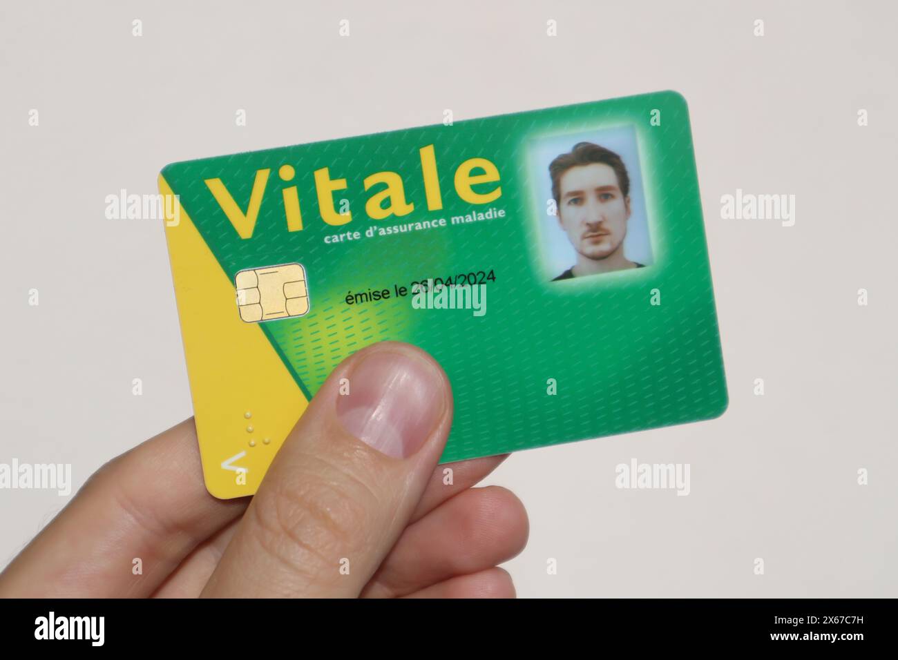 Young man's health insurance card of the national health care system in ...