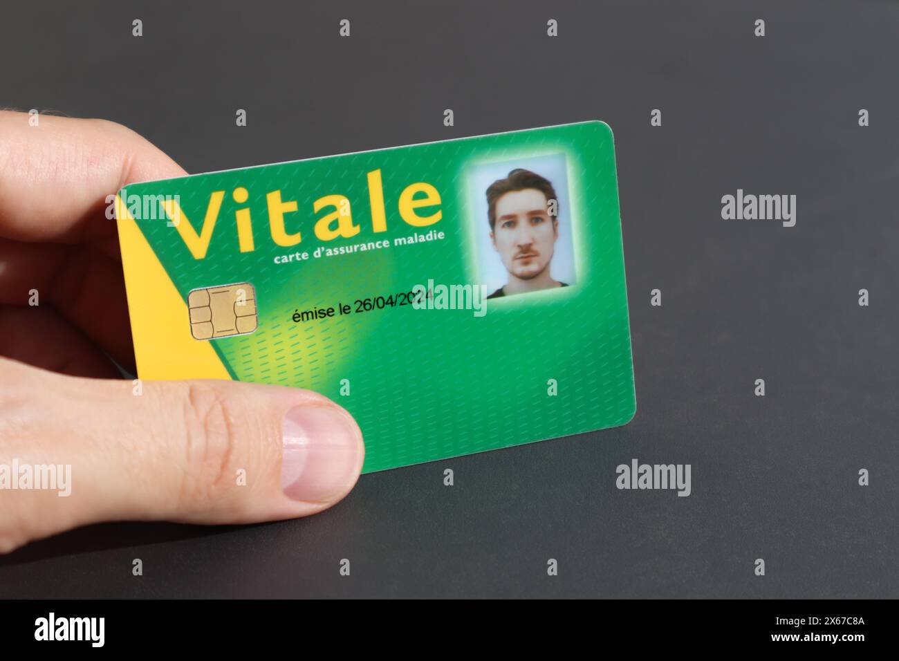Young man's health insurance card of the national health care system in ...