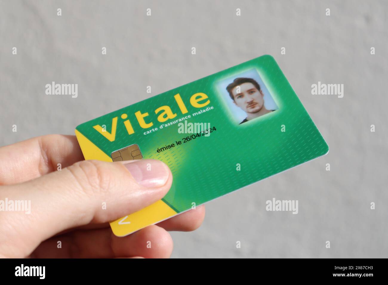 Young man's health insurance card of the national health care system in ...