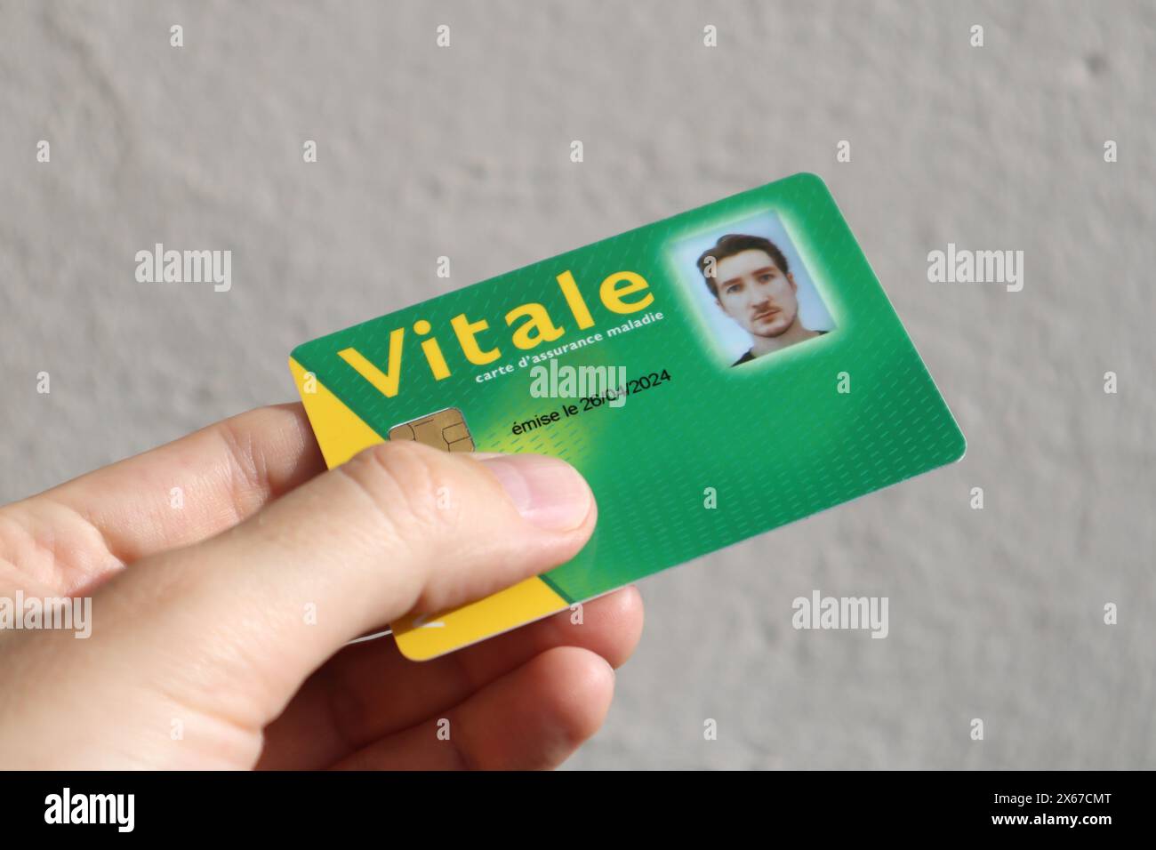 Young man's health insurance card of the national health care system in ...