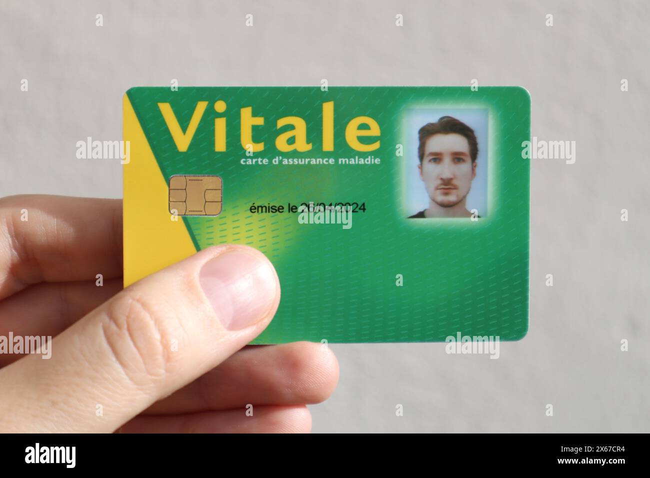 Young man's health insurance card of the national health care system in ...