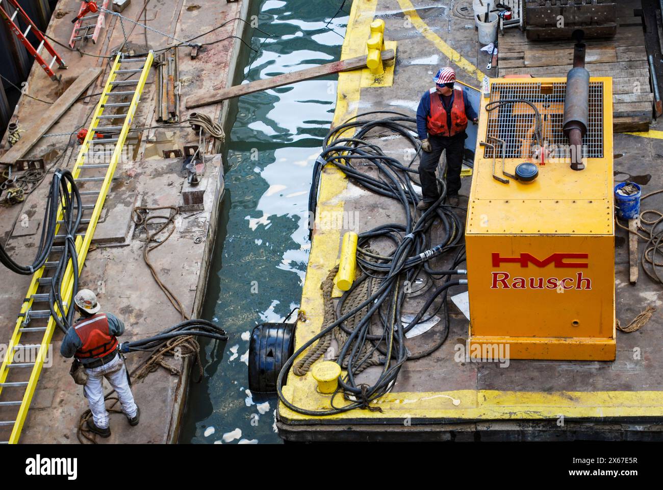 Worker on riverside construction Stock Photo - Alamy