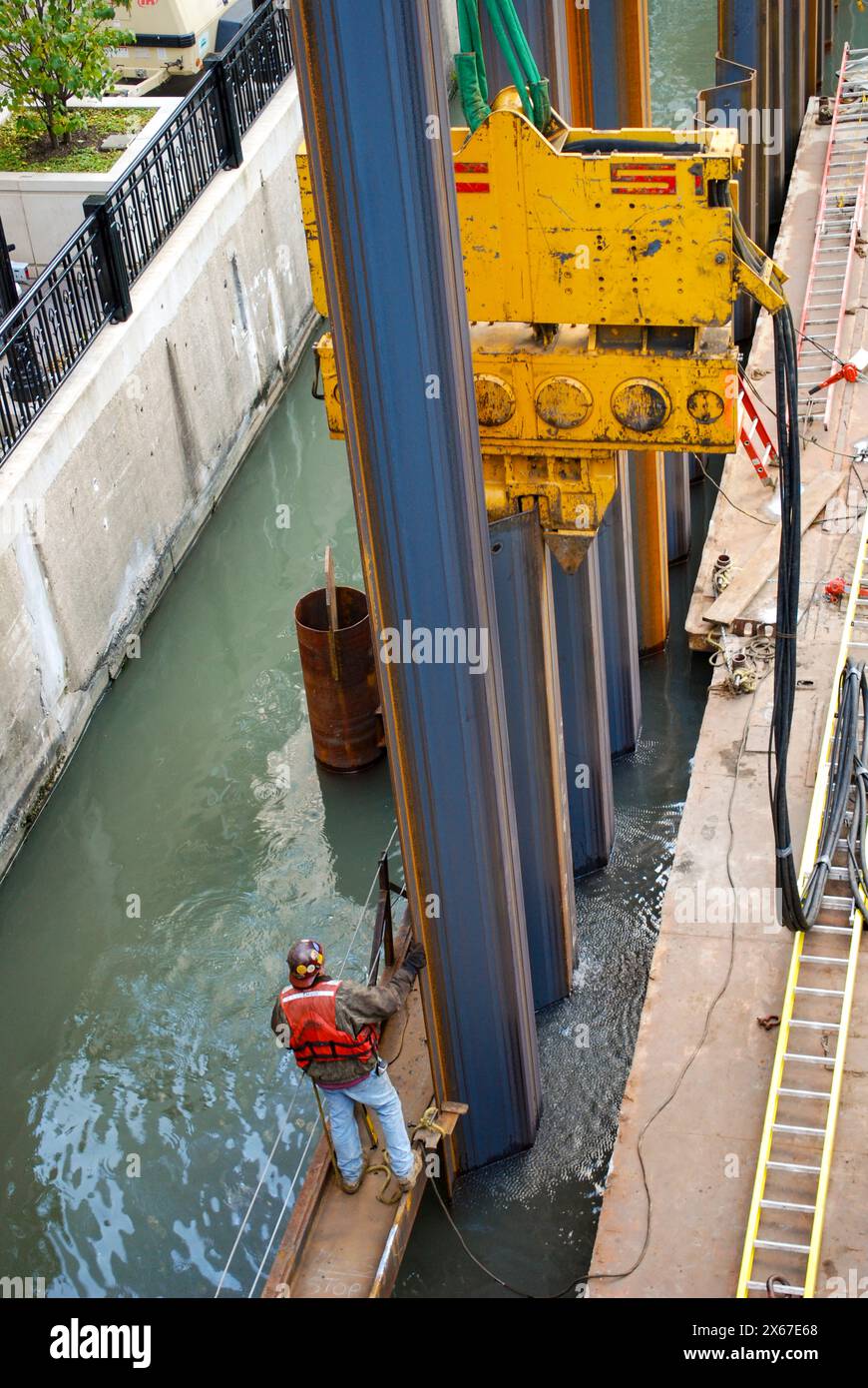 Worker on riverside construction Stock Photo - Alamy