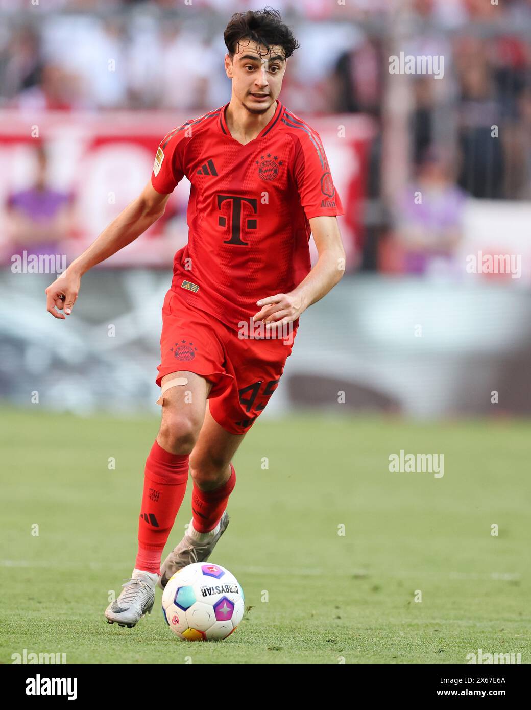 MUNICH, GERMANY - MAY 12: Aleksandar Pavlovic of Bayern Muenchen runs ...
