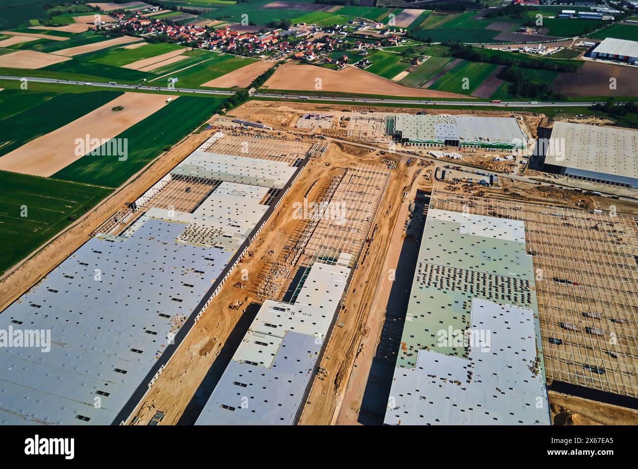 Aerial view of construction site with warehouse building under ...
