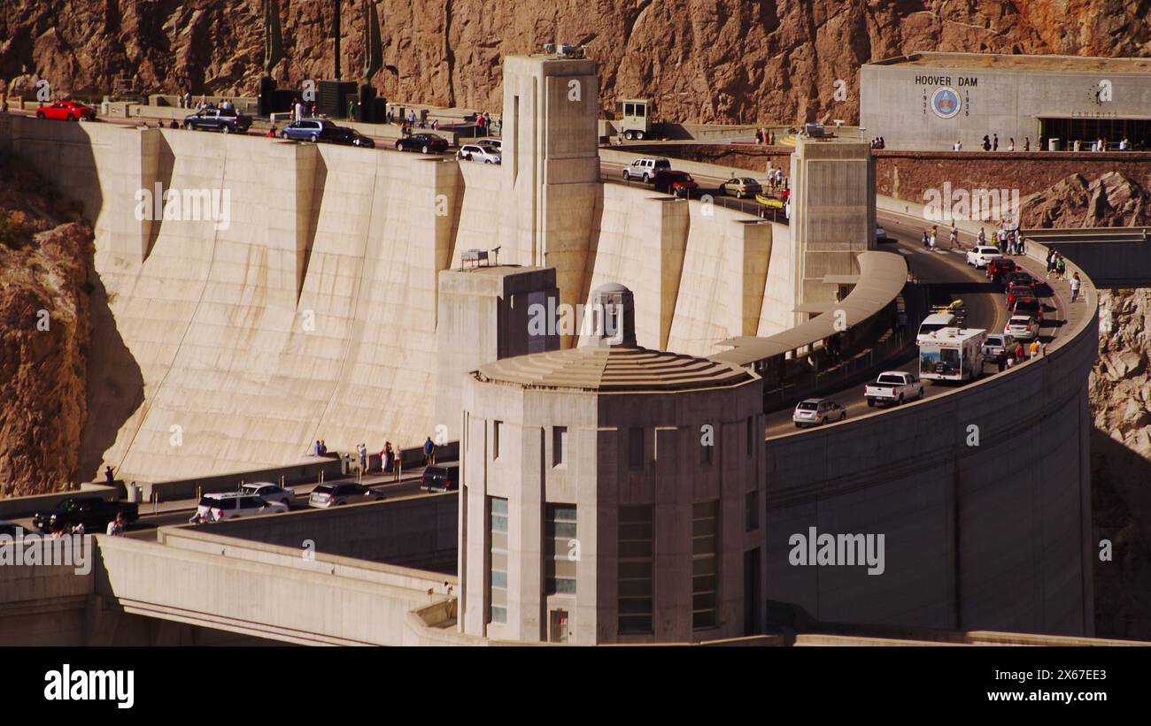 Motorist and heavy foot traffic follow the dam’s crest, spillway, and ...